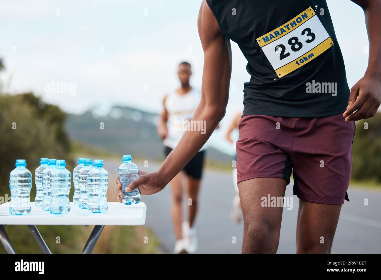 Hand, water and a marathon runner in a race or competition closeup for ...