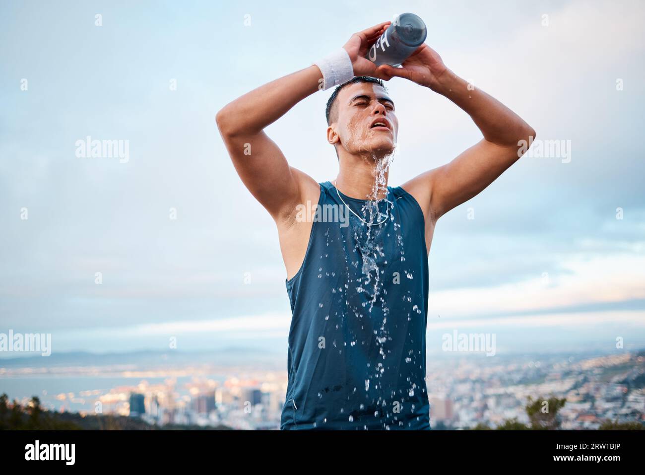 Fitness, water and fatigue with a sports man outdoor, tired after ...