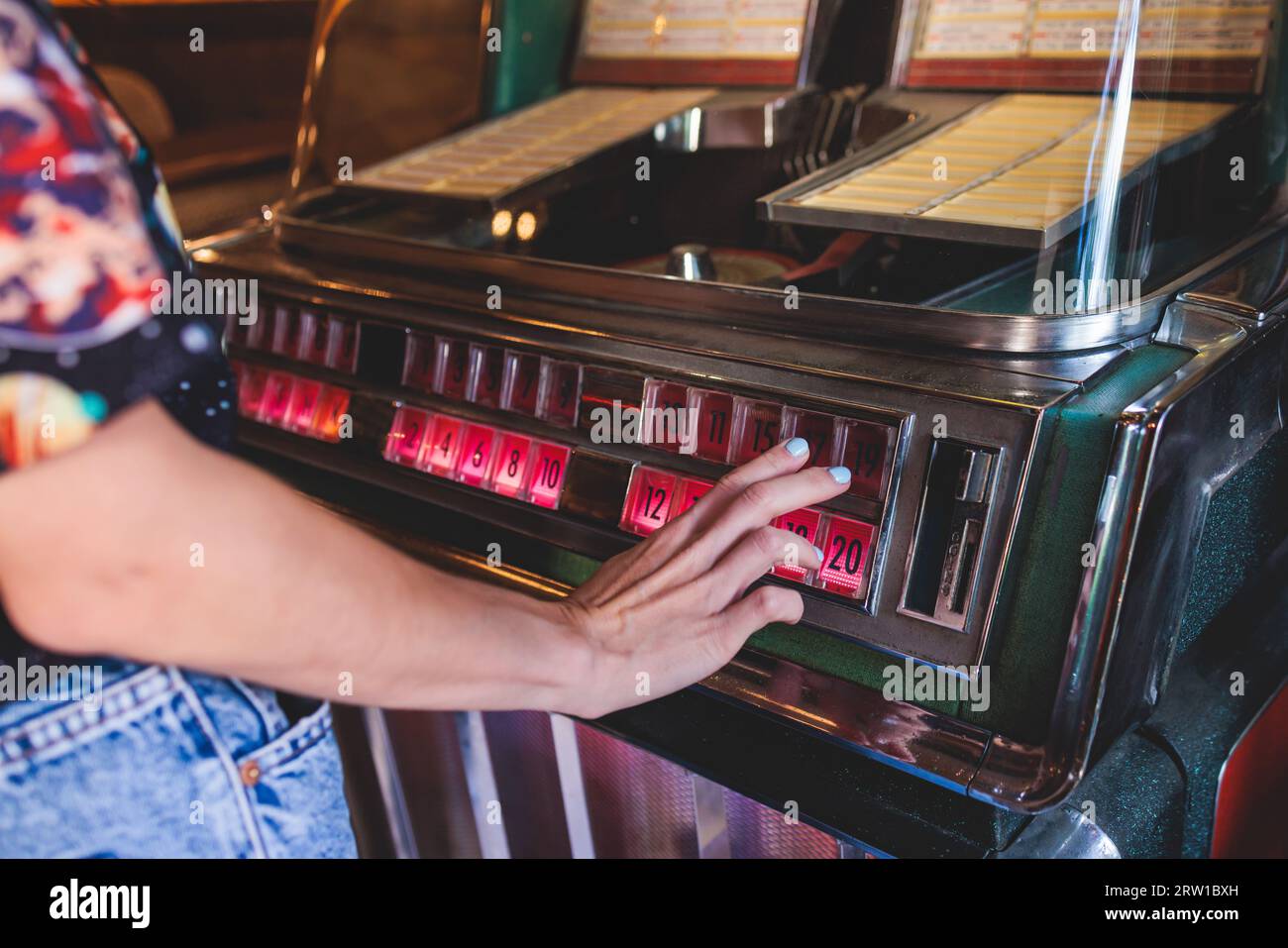 Vintage American music jukebox with illuminated buttons, process of ...