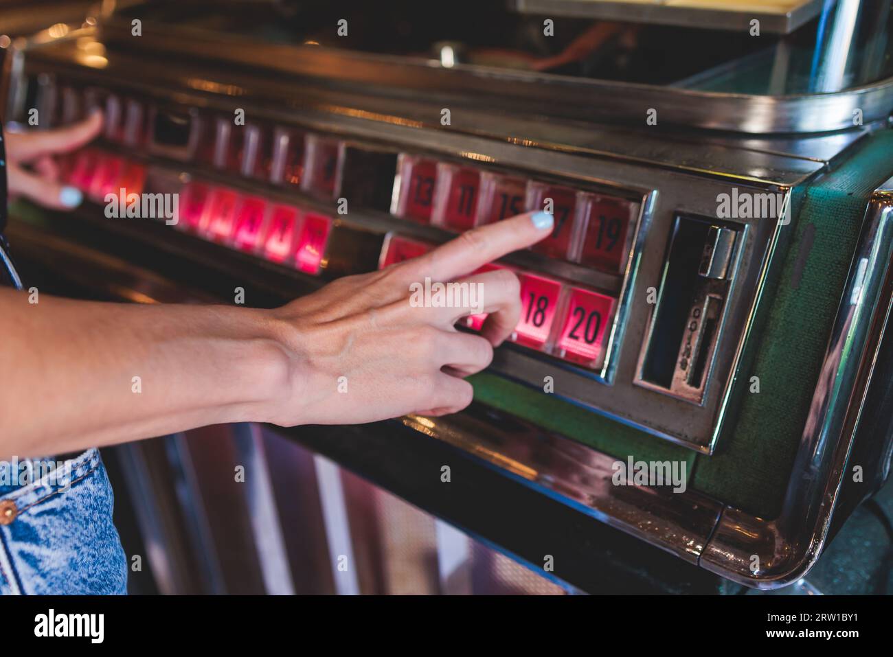 Vintage American music jukebox with illuminated buttons, process of ...