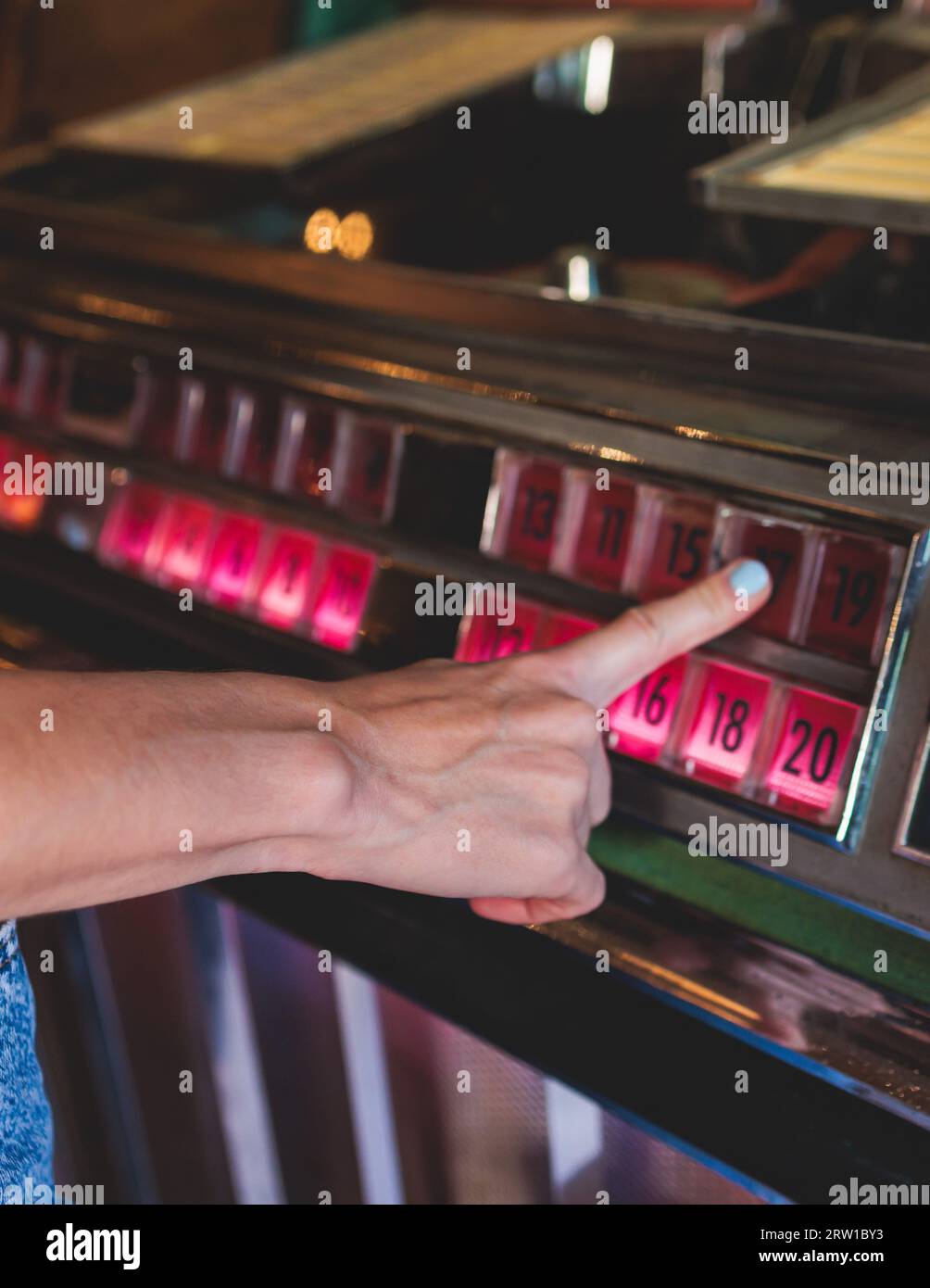Vintage American music jukebox with illuminated buttons, process of ...