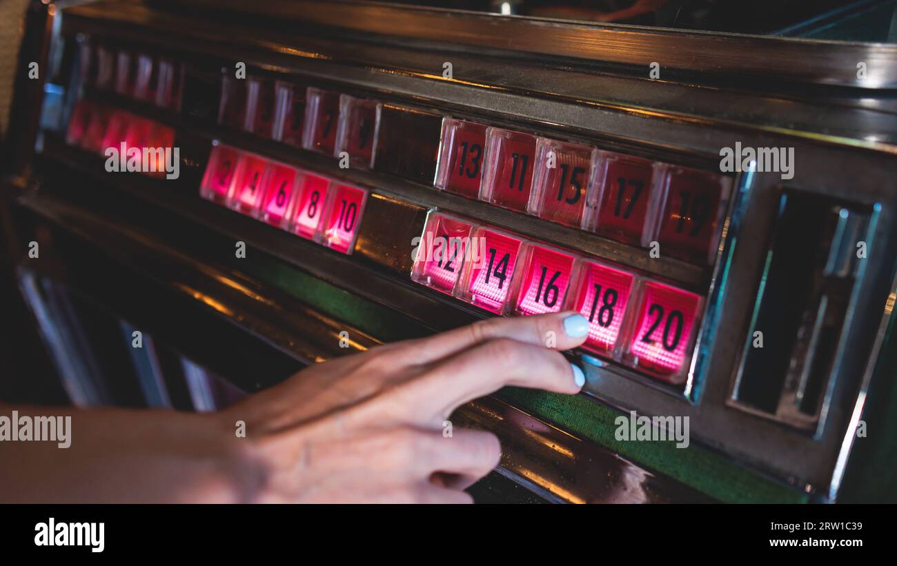 Vintage American music jukebox with illuminated buttons, process of ...