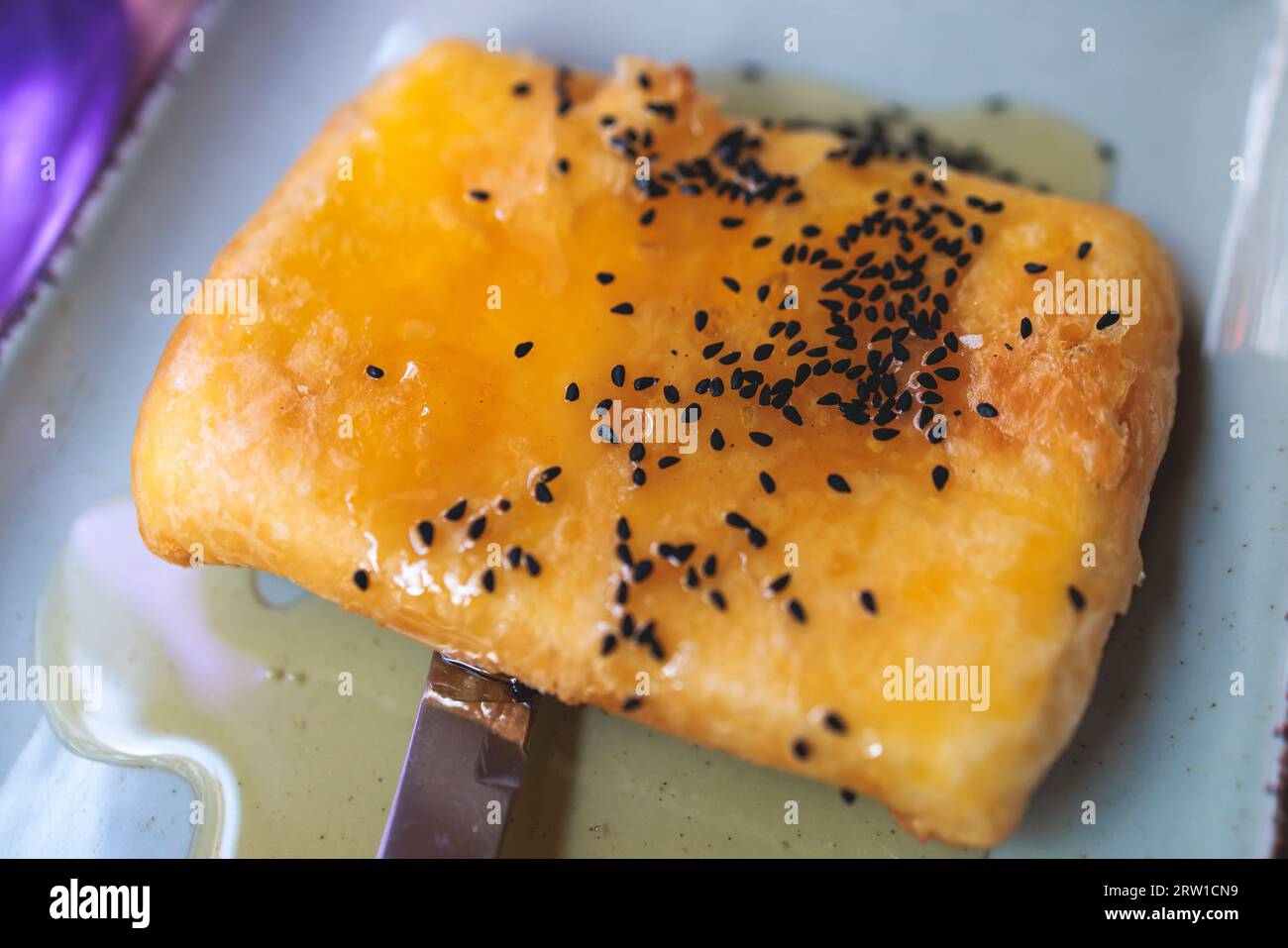 Fried feta cheese wrapped in phyllo pastry with honey and sesame ...