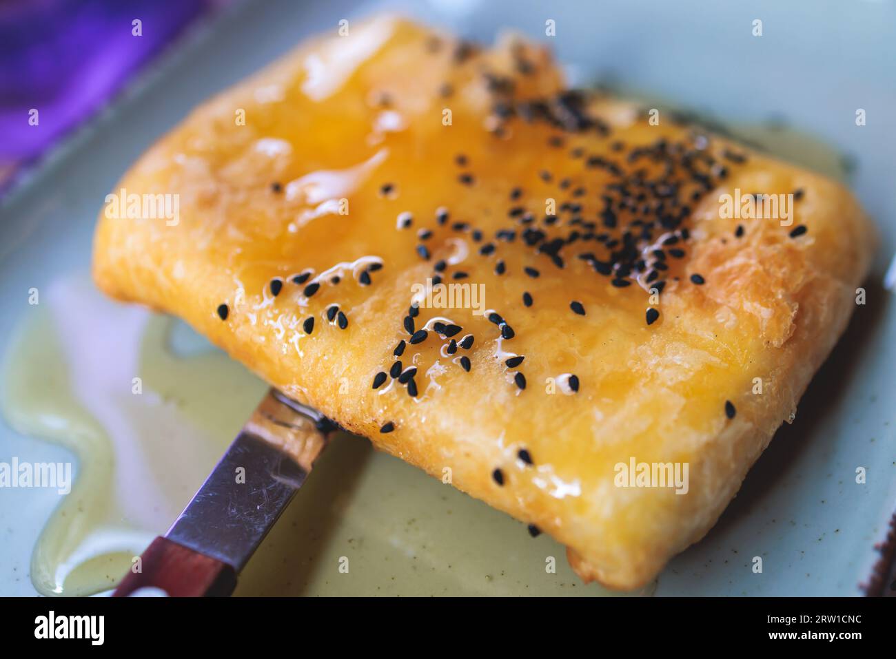 Fried feta cheese wrapped in phyllo pastry with honey and sesame ...