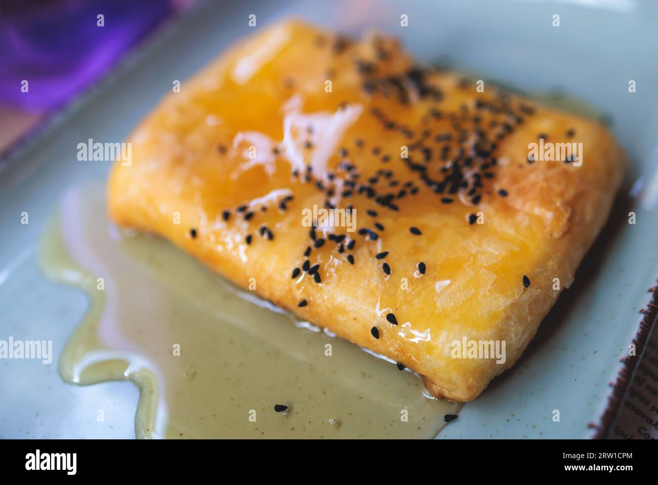 Fried feta cheese wrapped in phyllo pastry with honey and sesame ...