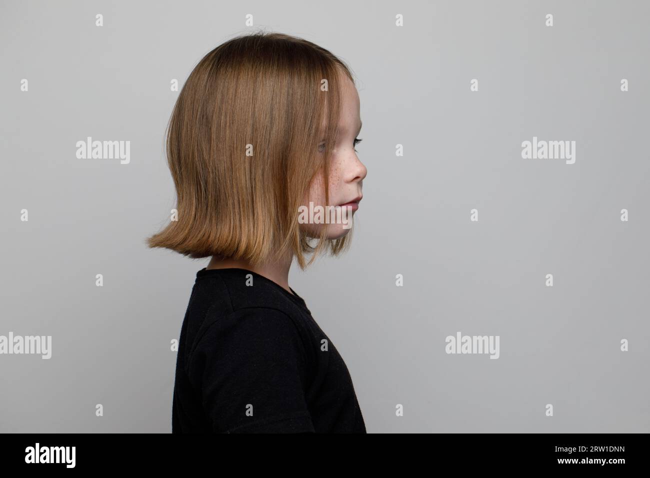 Profile side view face brown-haired little girl standing isolated on ...
