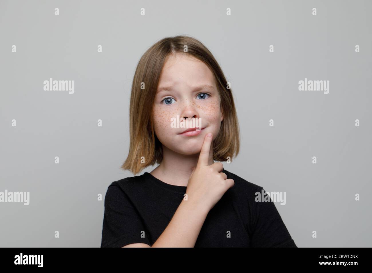 Idea, warning and childhood concept. Happy little child girl thinking ...