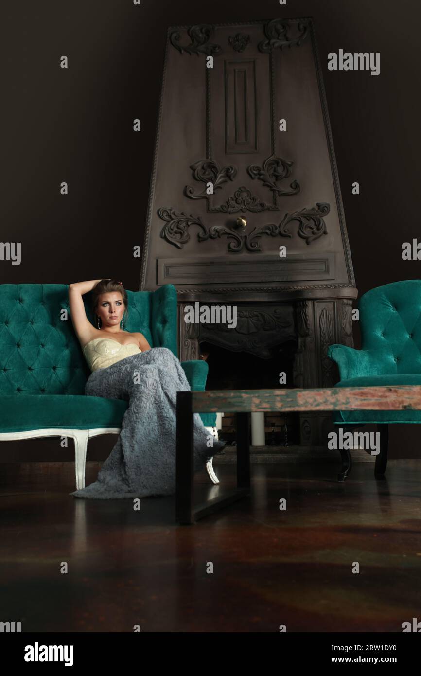 Gorgeous woman fashion model sitting in luxurious hotel room. Vogue ...