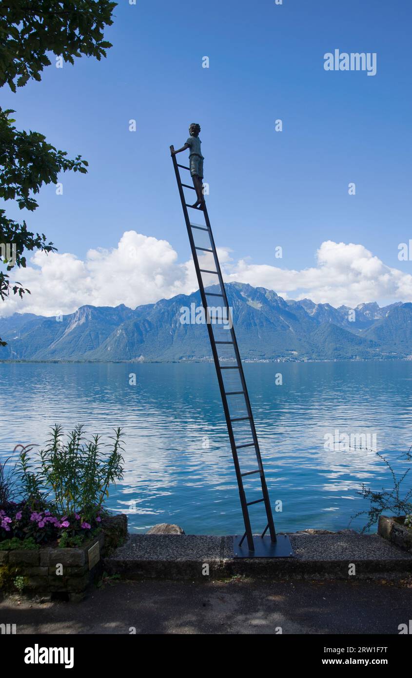 MONTREUX, SWITZERLAND - AUGUST 7, 2023: Bronze statue of boy climbing ...