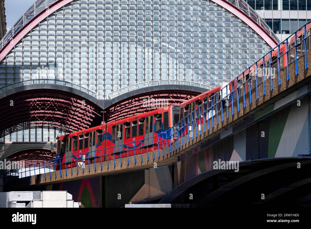 DLR train on elevated tracks crosses Middle Dock towards Canary Wharf ...