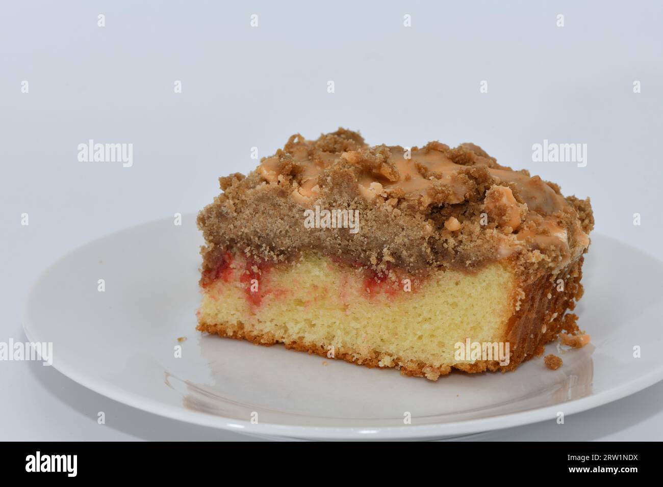 A slice of raspberry crumb cake on a plate Stock Photo - Alamy