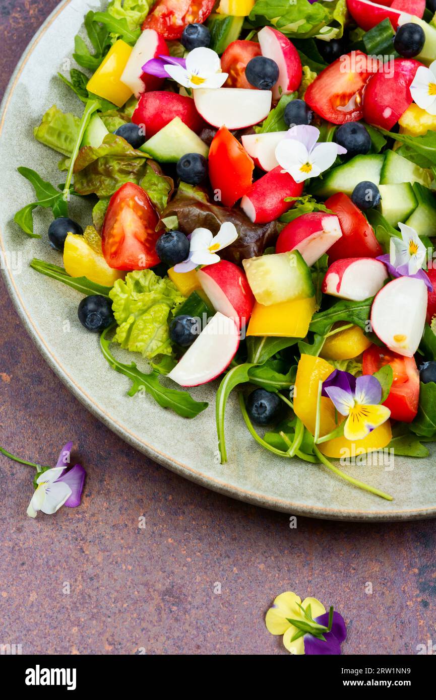 Spring salad with vegetable and edible flowers violets. Clean eating ...