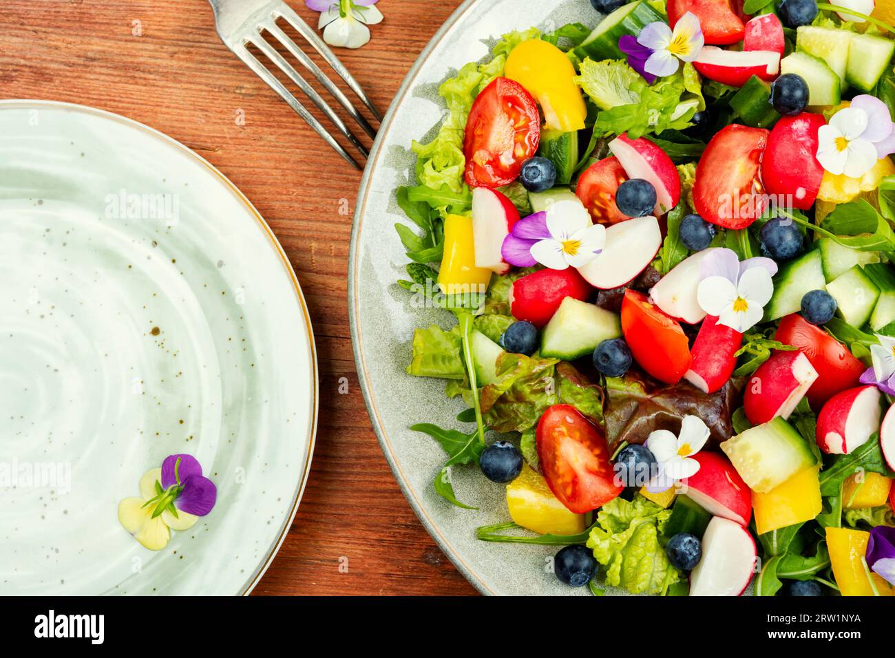 Spring salad with vegetable and edible flowers violets. Clean eating ...