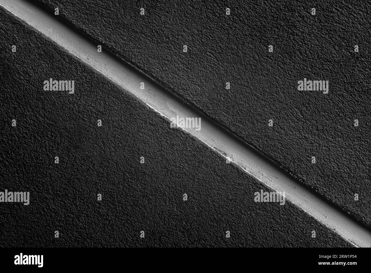 A black wall texture divided in half by a line Stock Photo - Alamy