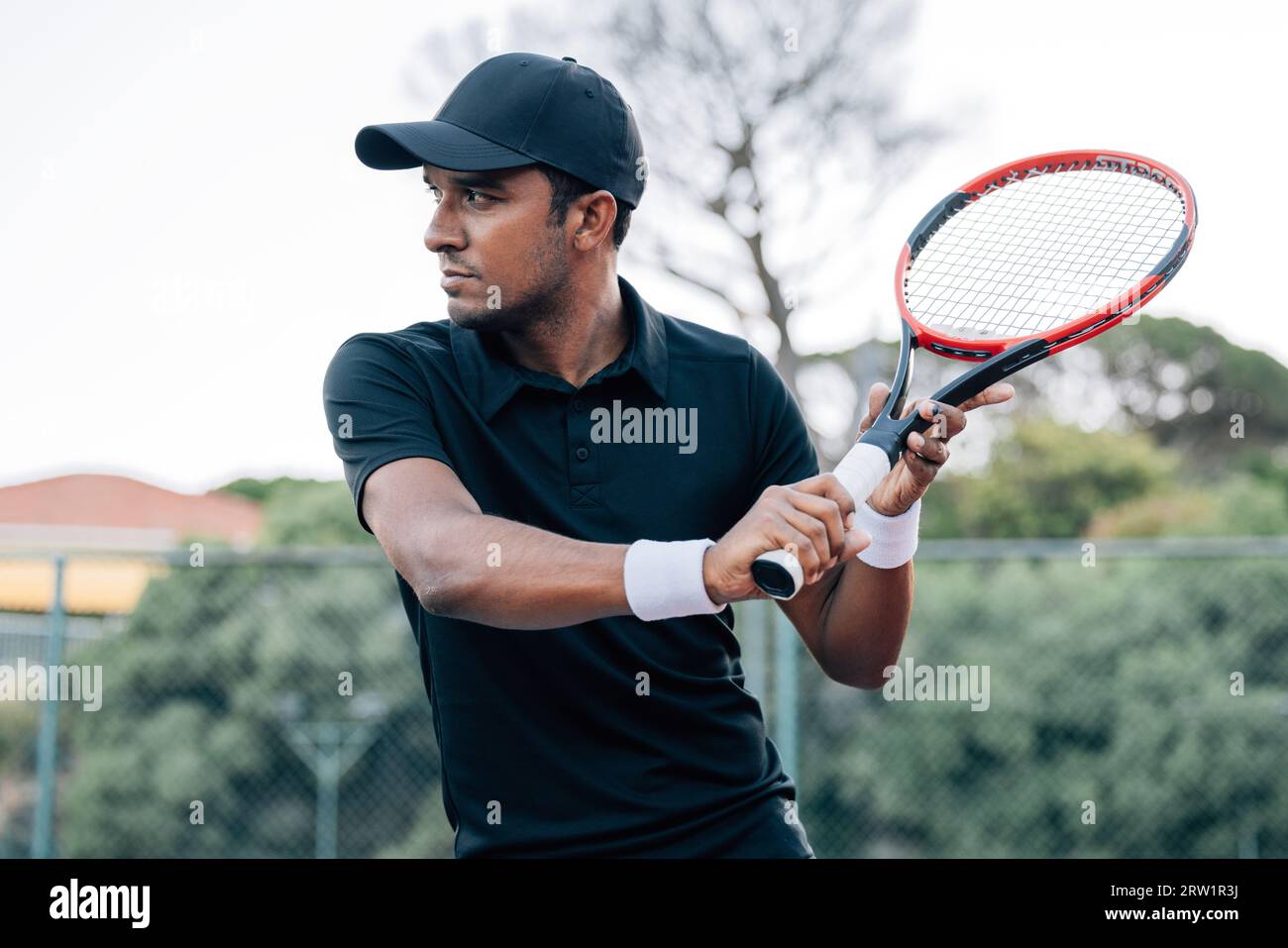 Side view of confident tennis player with racket outdoors Stock Photo ...