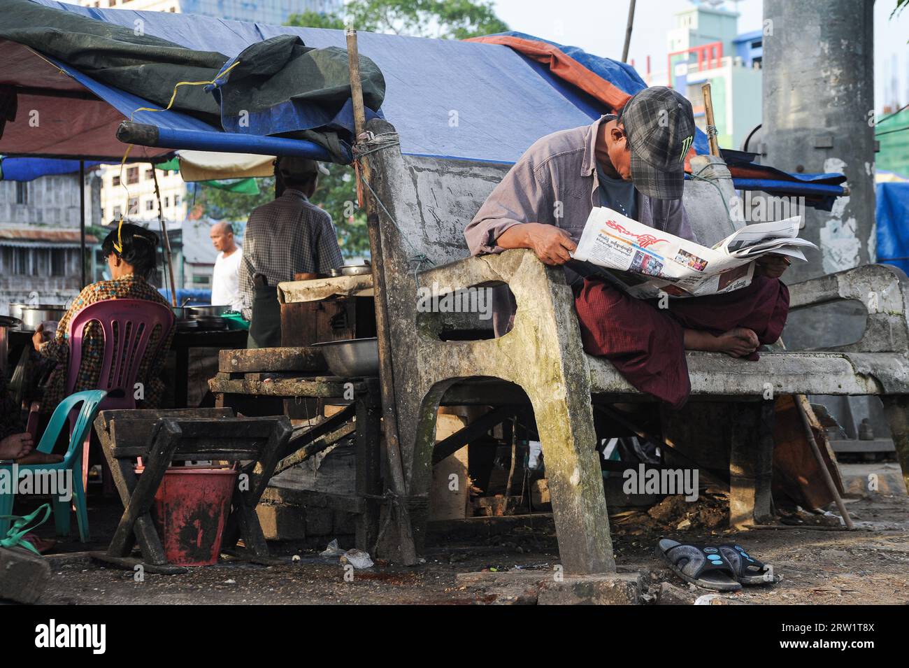 Newspaper man reading myanmar hi-res stock photography and images - Alamy