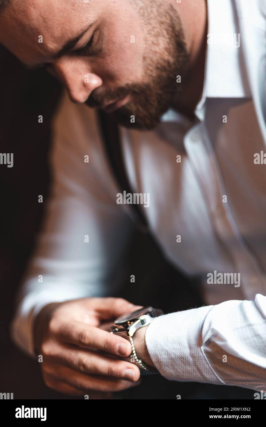 Handsome businessman looking wrist hi-res stock photography and images ...