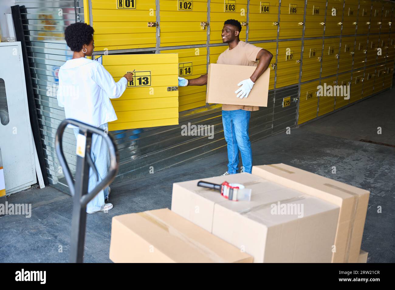 African American man loading a cardboard box into storage unit Stock ...