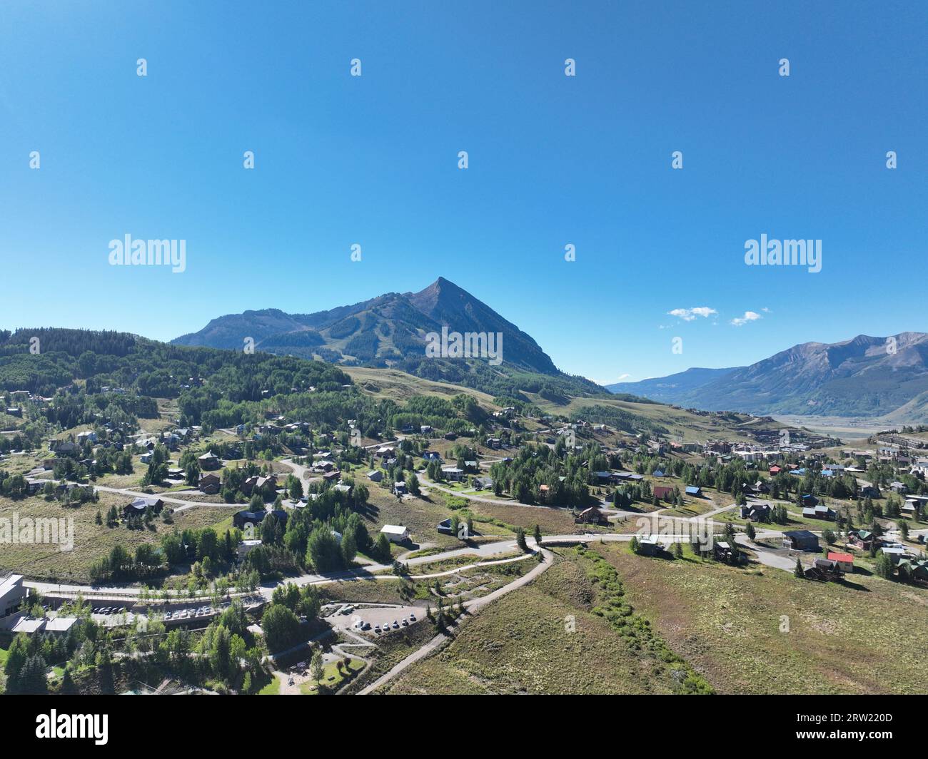 An aerial view of a suburban cityscape nestled atop a hill, featuring ...