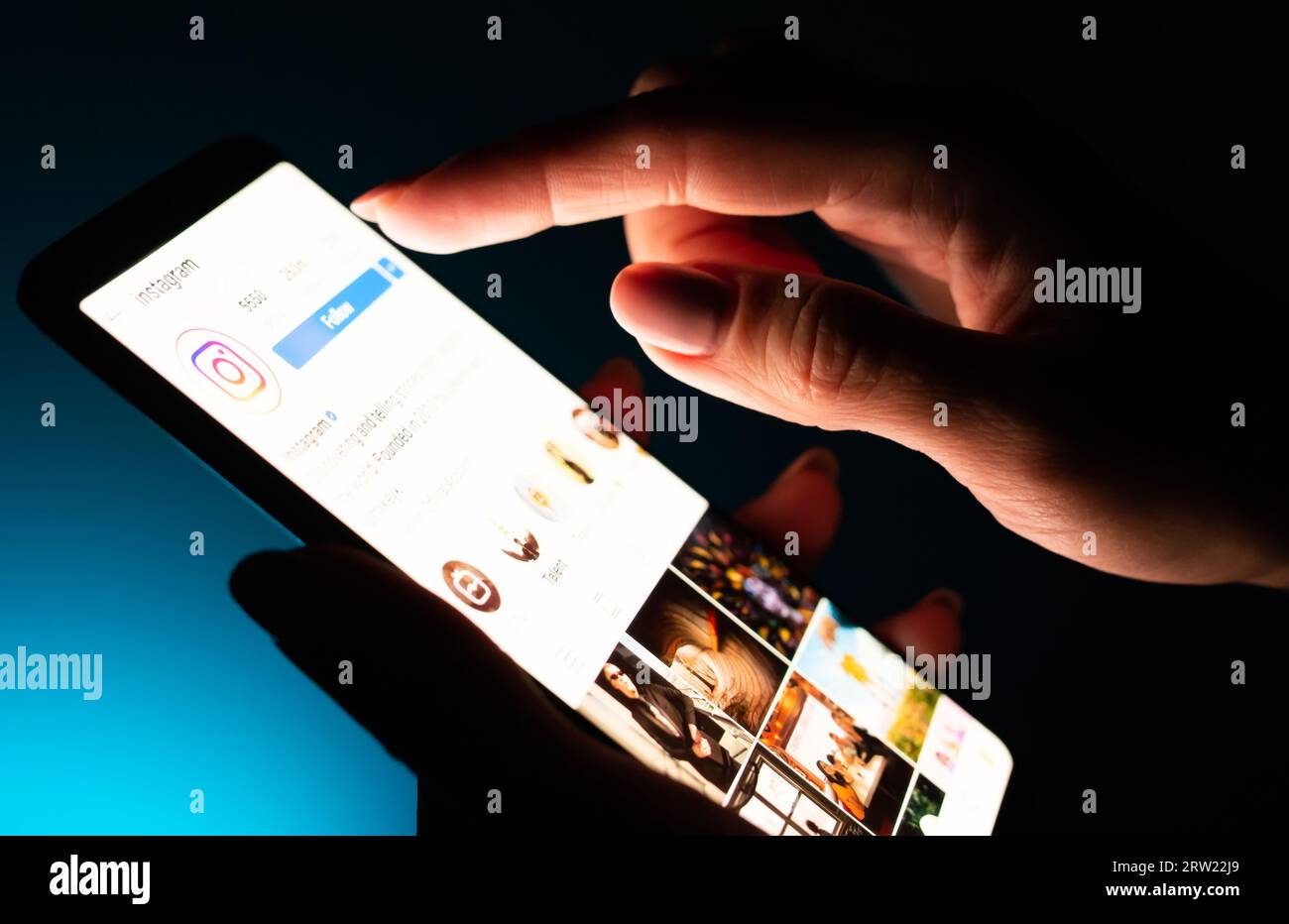Instagram logo mobile hand dark hi-res stock photography and images - Alamy