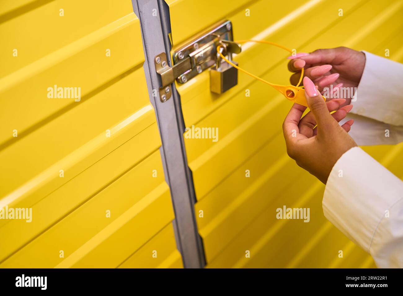 African American female touches a sealed lock Stock Photo - Alamy