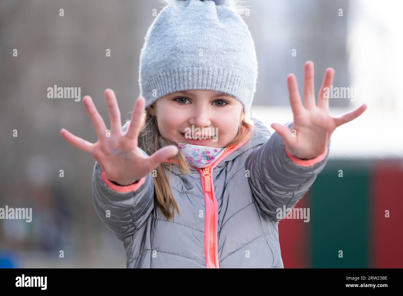 Adorable little girl waving hello with chalk covered palms Stock Photo ...