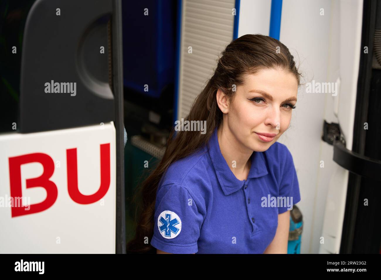 Mobile team medic sat down to rest on footboard of ambulance Stock Photo - Alamy