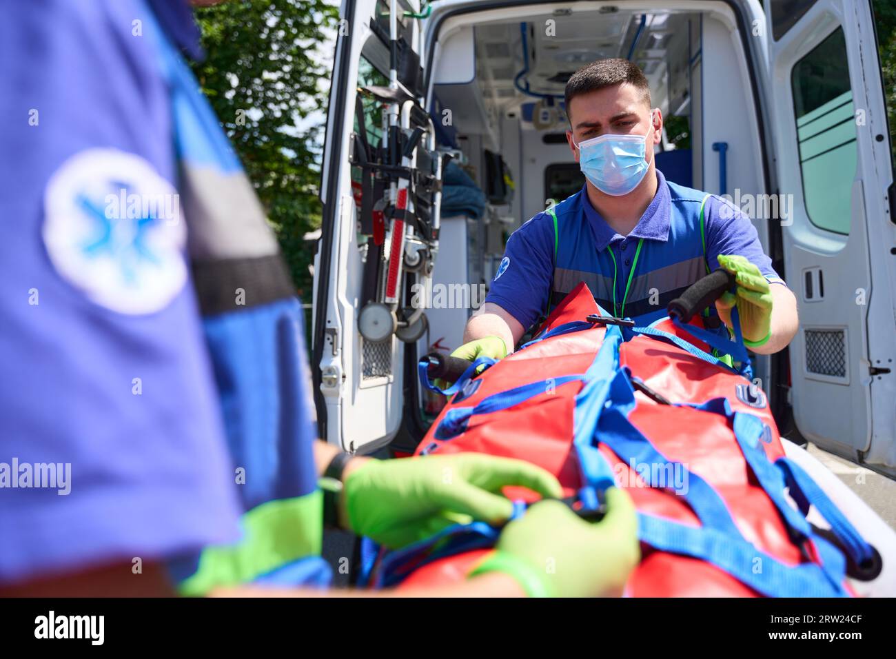 Male medics fix the victim in accident on special stretcher Stock Photo ...