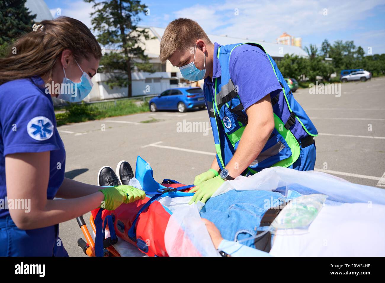 Paramedics fix the patients legs for transportation on special ...