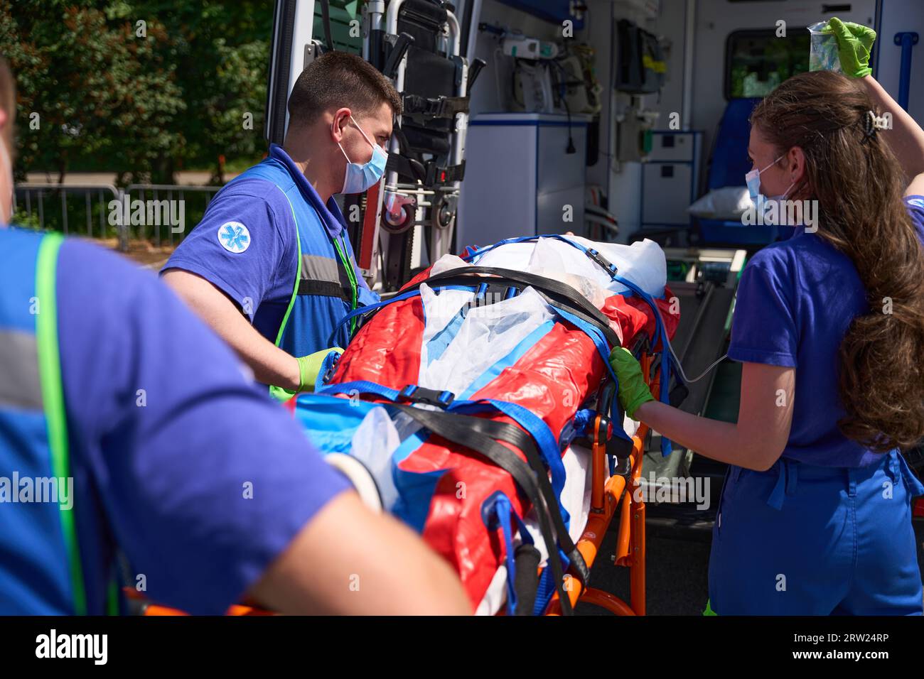 Ambulance team transports the patient on special stretcher to ambulance ...