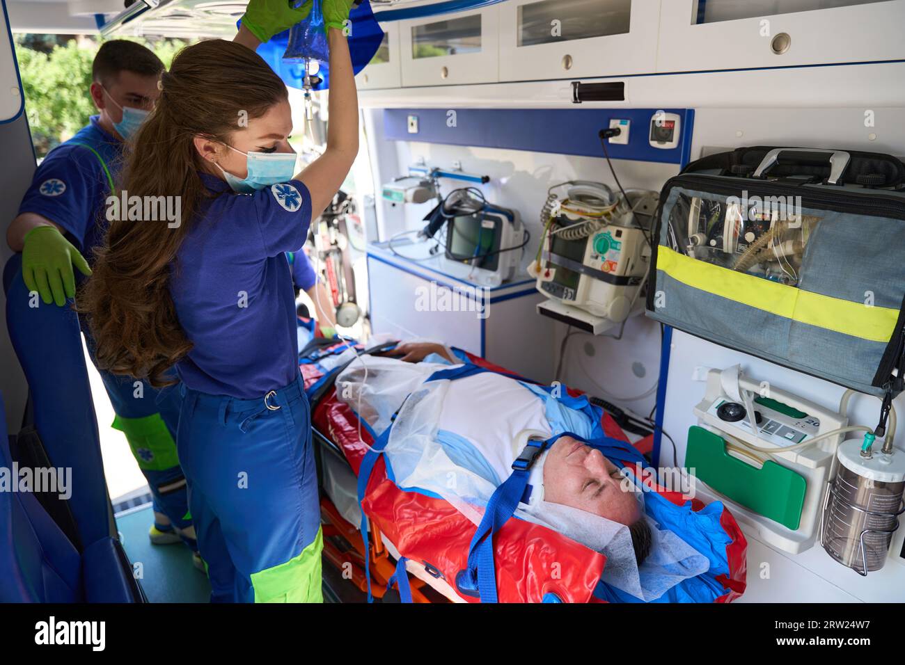 Team of paramedics transports a patient with polytrauma Stock Photo - Alamy