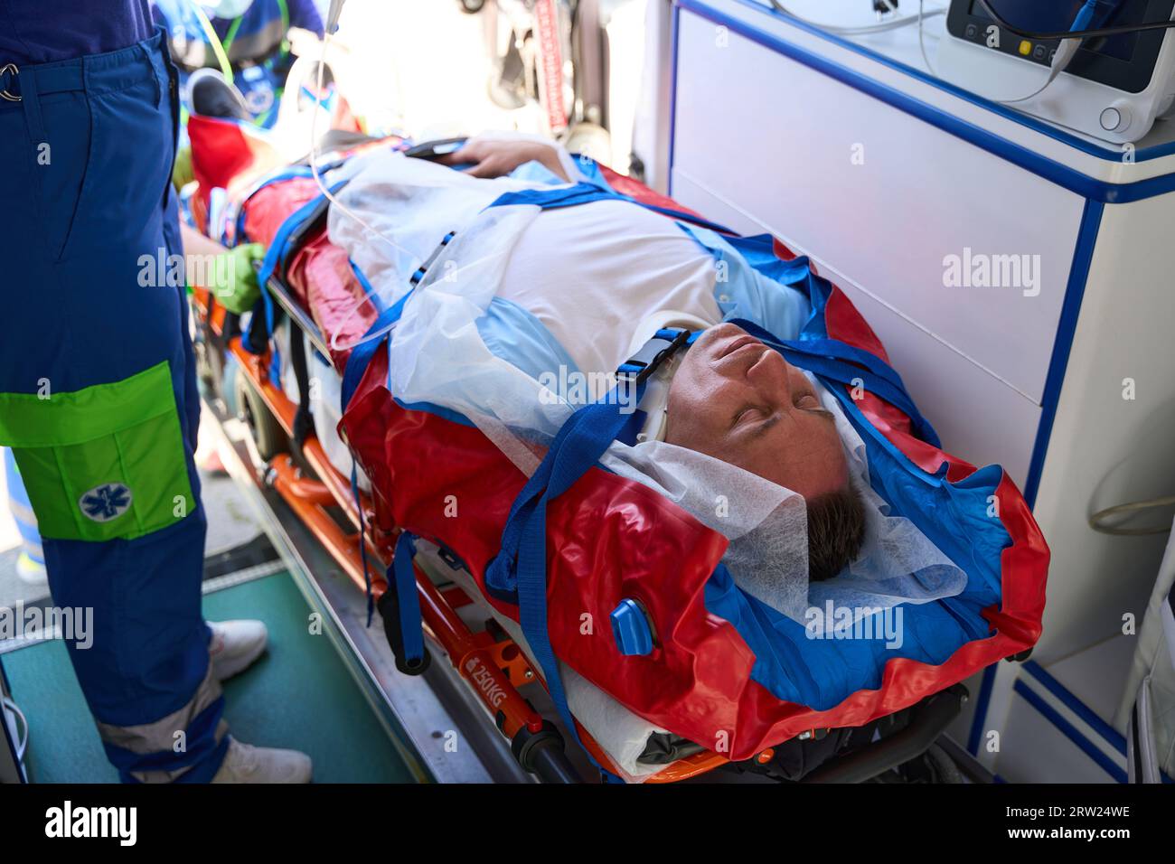Patient on a stretcher is loaded into an ambulance Stock Photo - Alamy