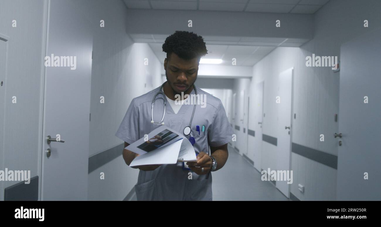 African American health care specialist with tests results in hands ...