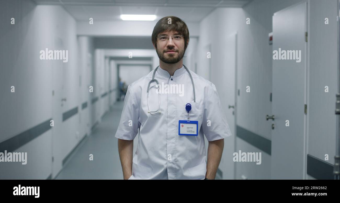 Young doctor in glasses looks at camera and smiles. Professional medic ...