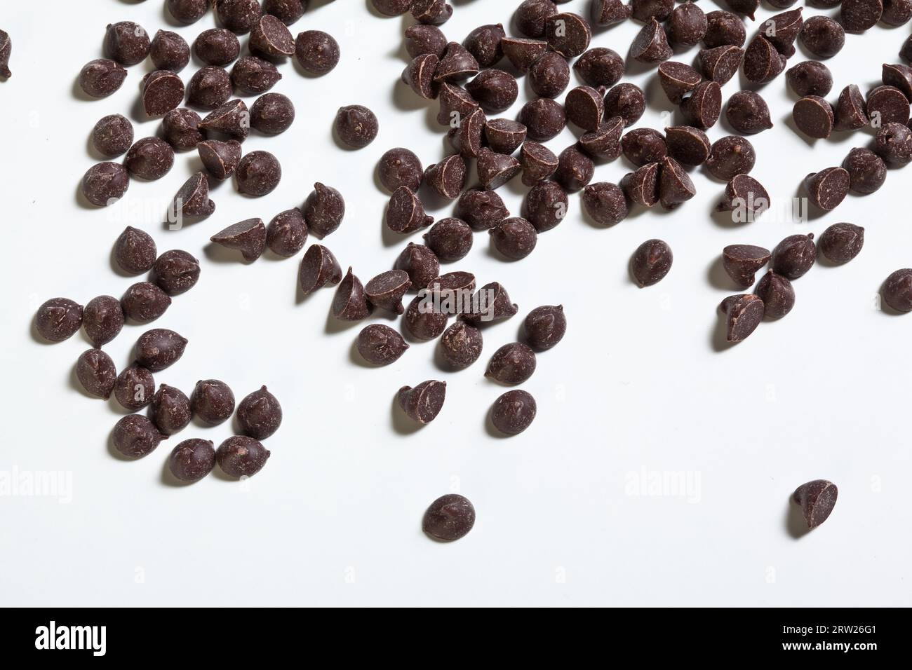 Row of chocolate chips on white background Stock Photo - Alamy