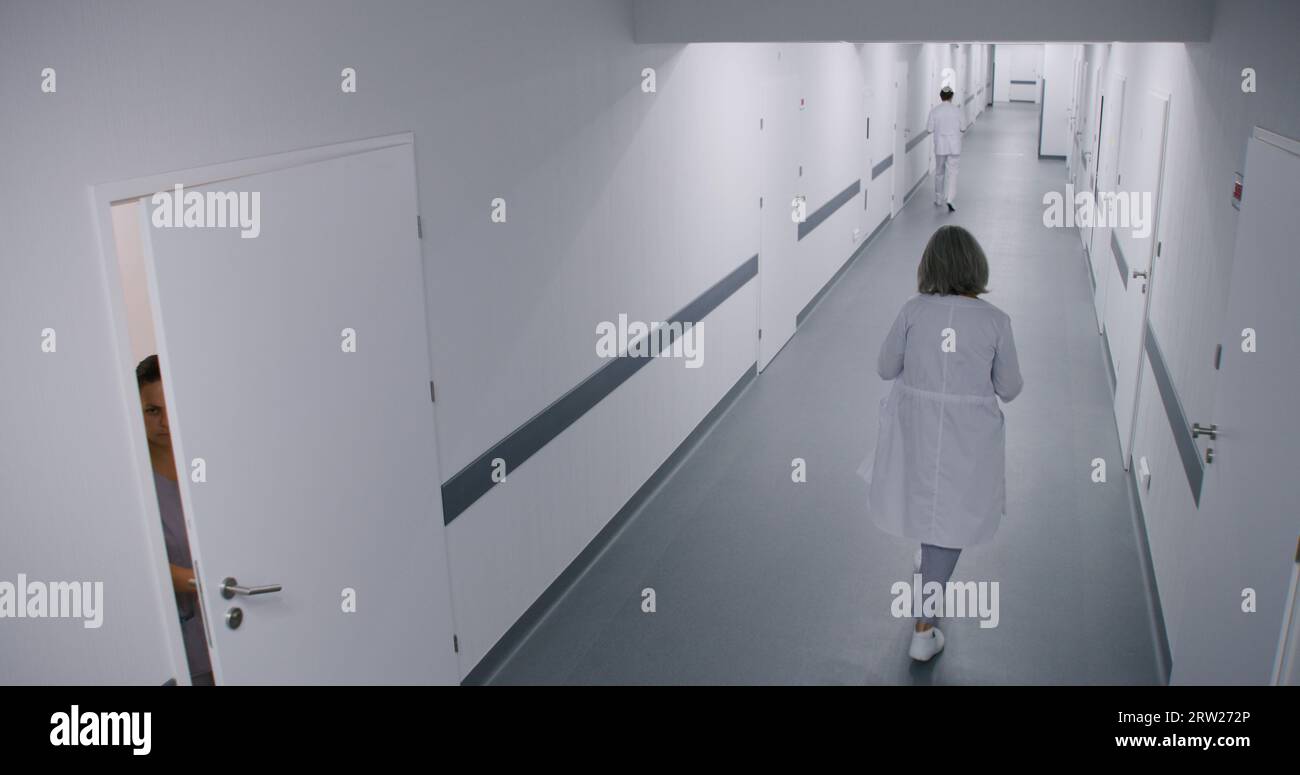 Clinic corridor: Busy doctors, professional medics, nurses, physicians ...