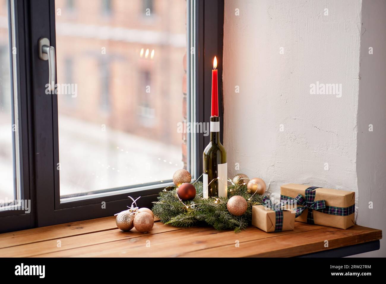 christmas wreath with candle burning on bottle Stock Photo - Alamy