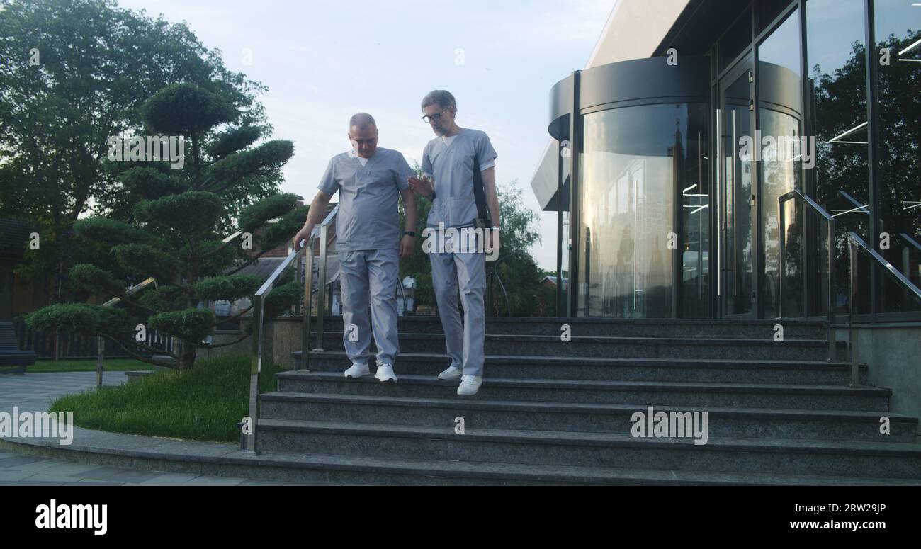 Team doctors walk outside modern hi-res stock photography and images ...