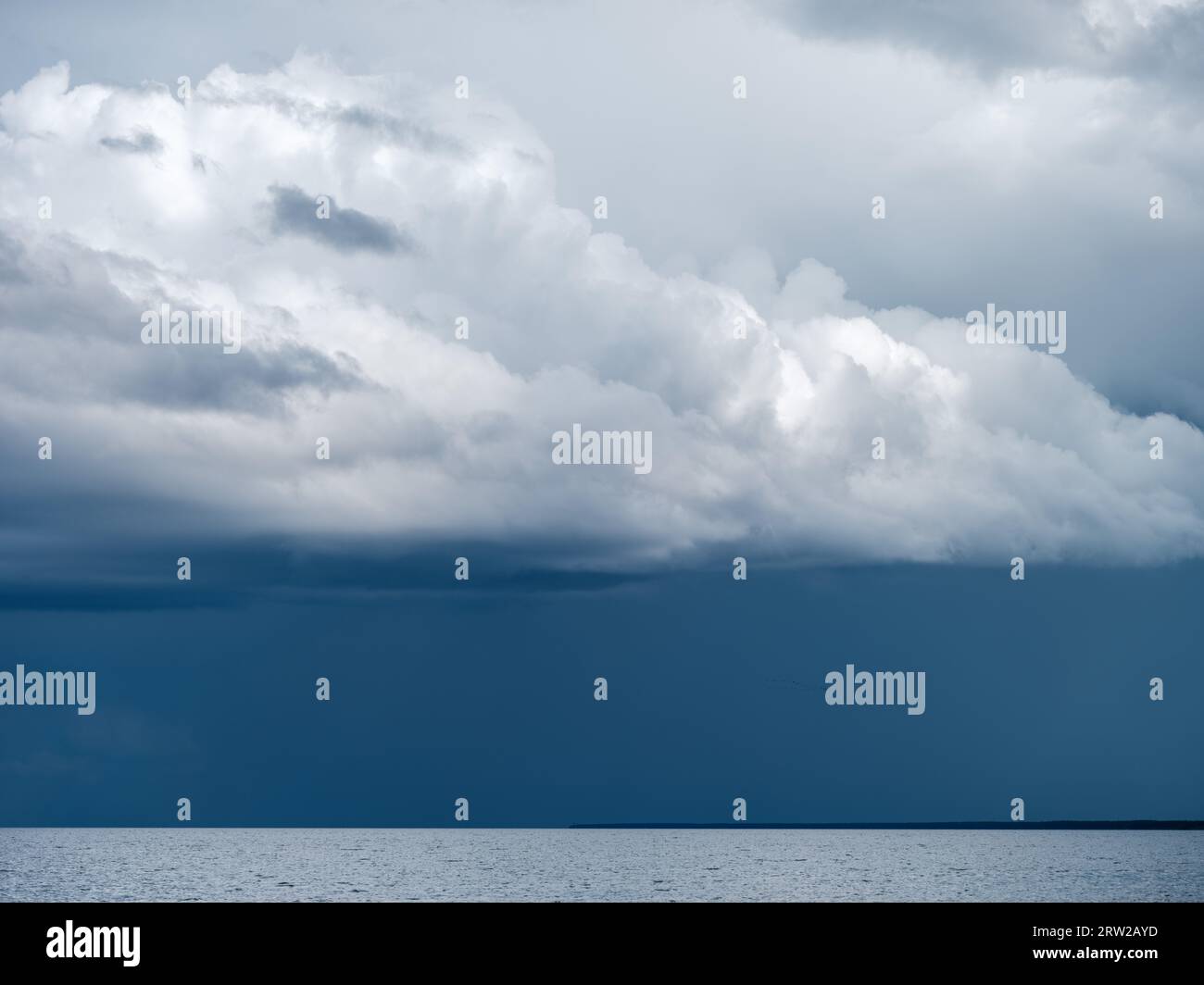 white rain clouds over countryside in summer with blue sky and high ...