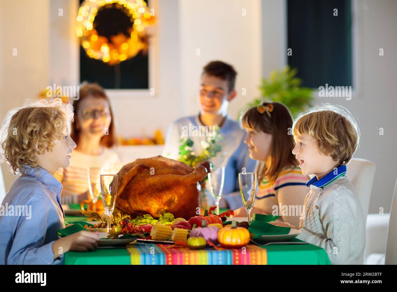 Family at Thanksgiving dinner. Parents, grandparents and kids enjoy ...