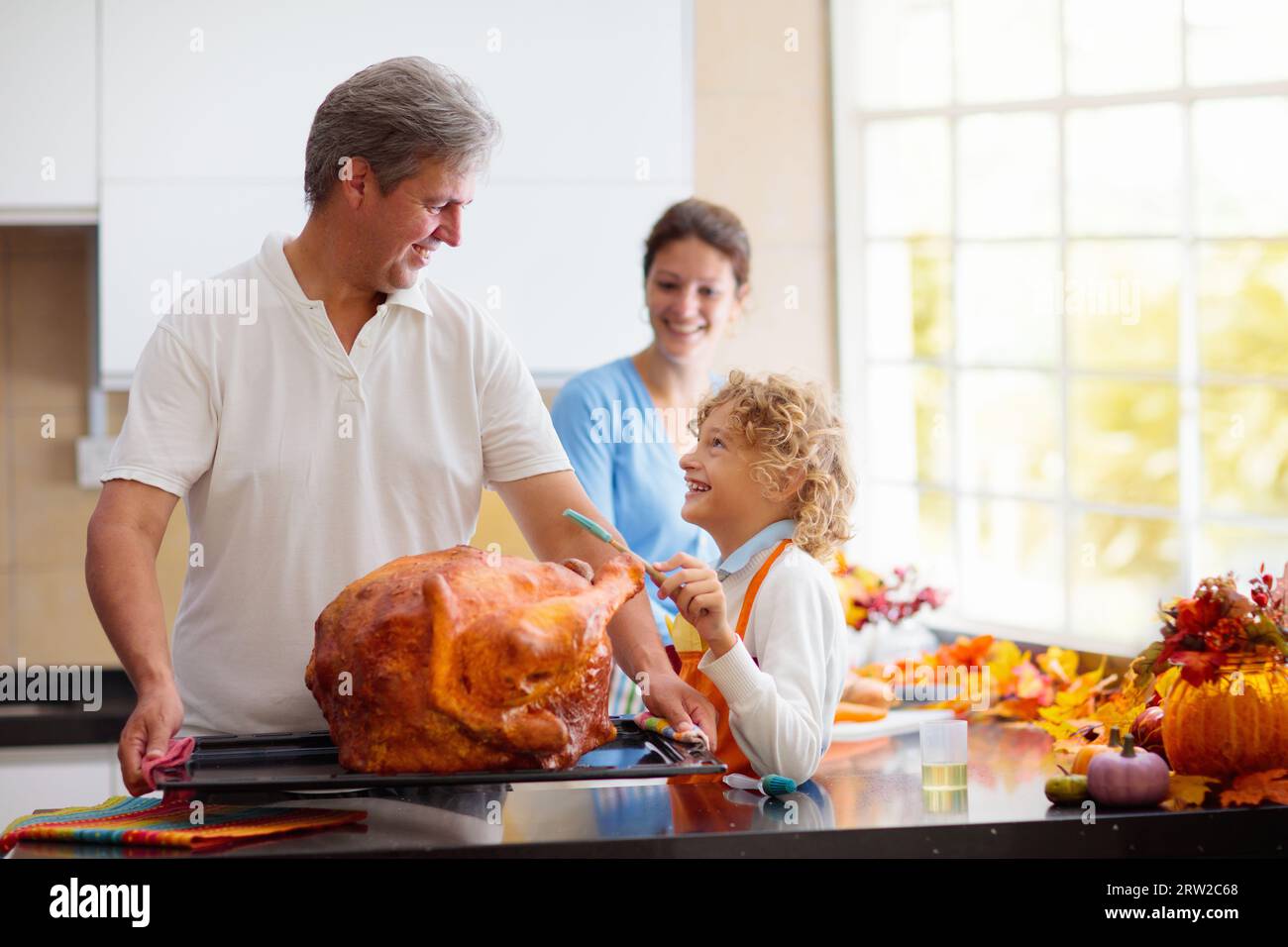 Turkey for Thanksgiving. Family cooking festive dinner. Mother, father ...
