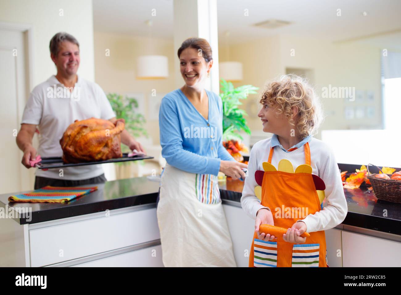 Turkey for Thanksgiving. Family cooking festive dinner. Mother, father ...