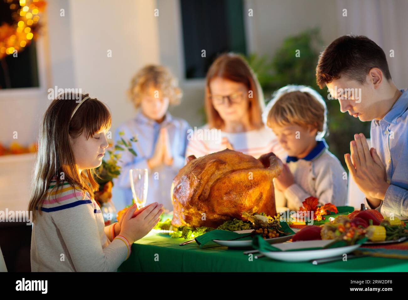 Family at Thanksgiving dinner. Parents, grandparents and kids enjoy ...