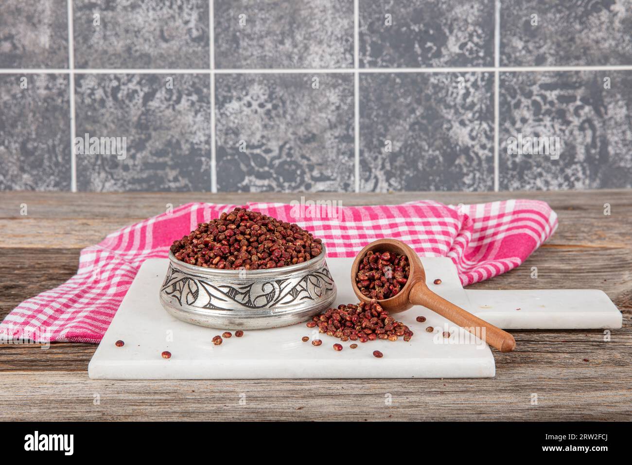 Dry spice sumac in a wooden spoon. Ground sumac spice. Dried ground red ...