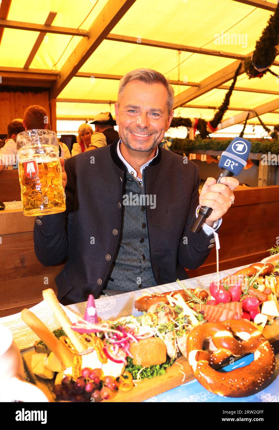 The presenter of the bavarian tv broadcast with traditional food hi-res ...