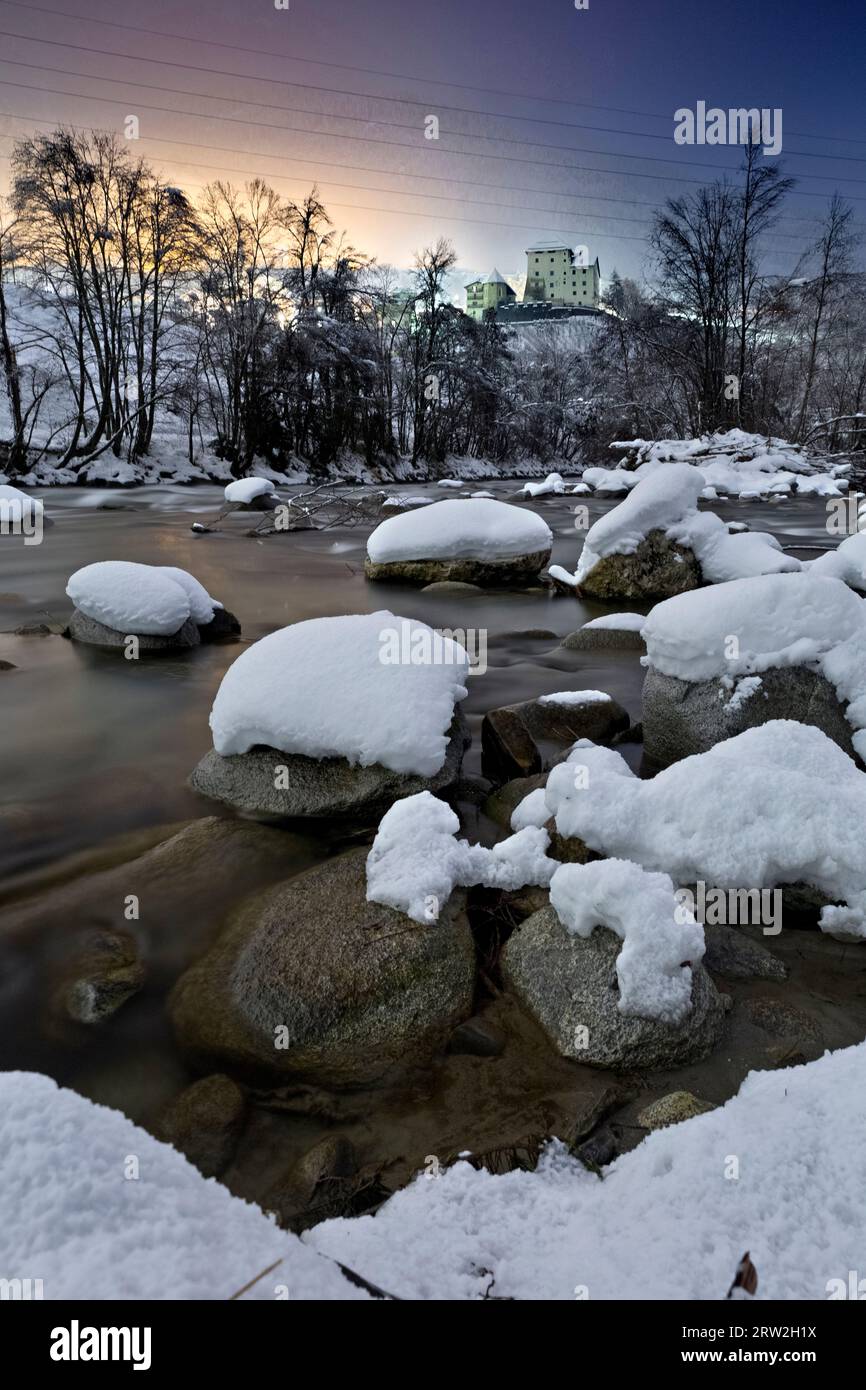The Noce stream and the medieval castle of Caldes on a winter night ...
