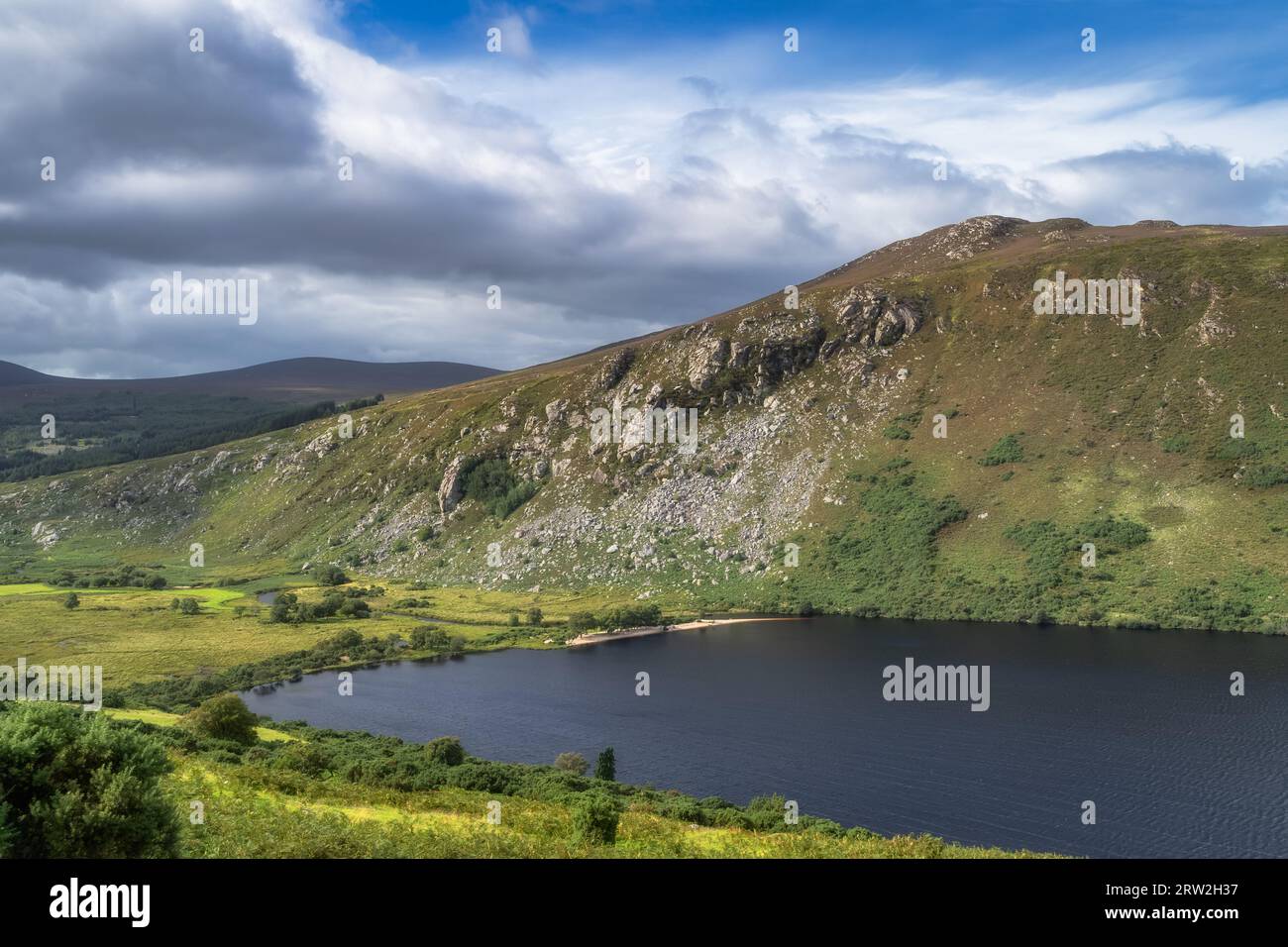 Beautiful panorama with lake, beach, forest, valley and rocky steep ...