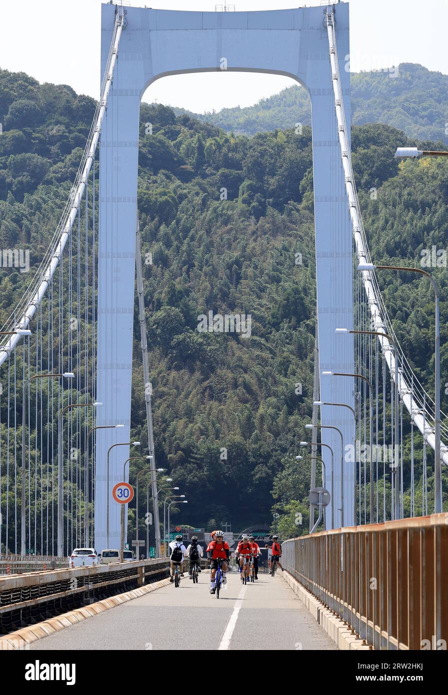 People ride tandem bicycles across Nishiseto Expressway (Shimanami ...