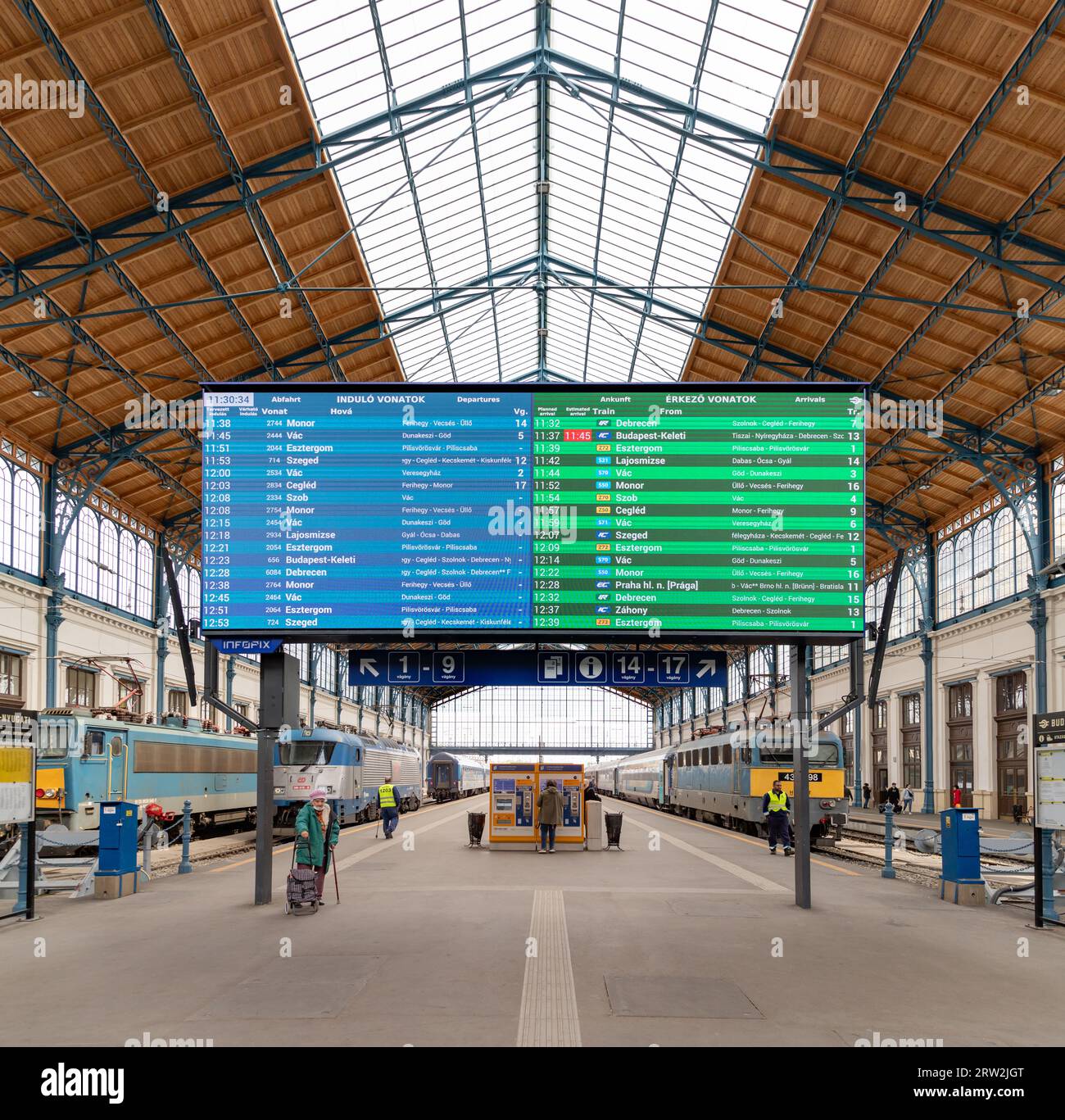 A picture of the Nyugati train station with a large timetable screen on ...