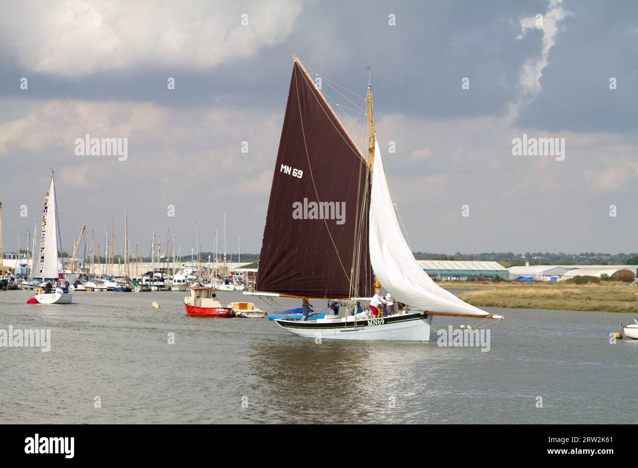 Maldon Regatta 2023. Parade of Sail down the River Chelmer with boats displaying their colourful ...